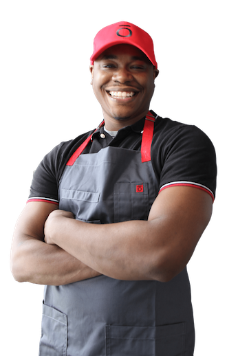 Roti Team member smiling while wearing an apron and hat